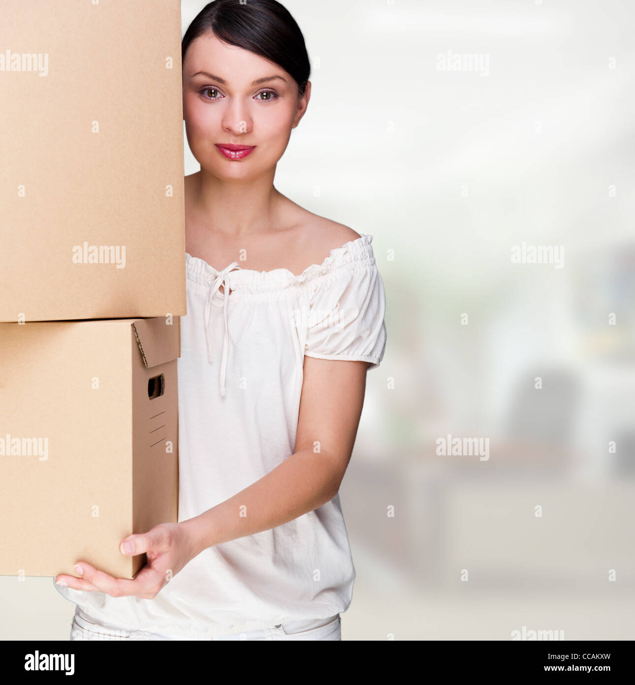 Attractive woman with box making a removal Stock Photo - Alamy