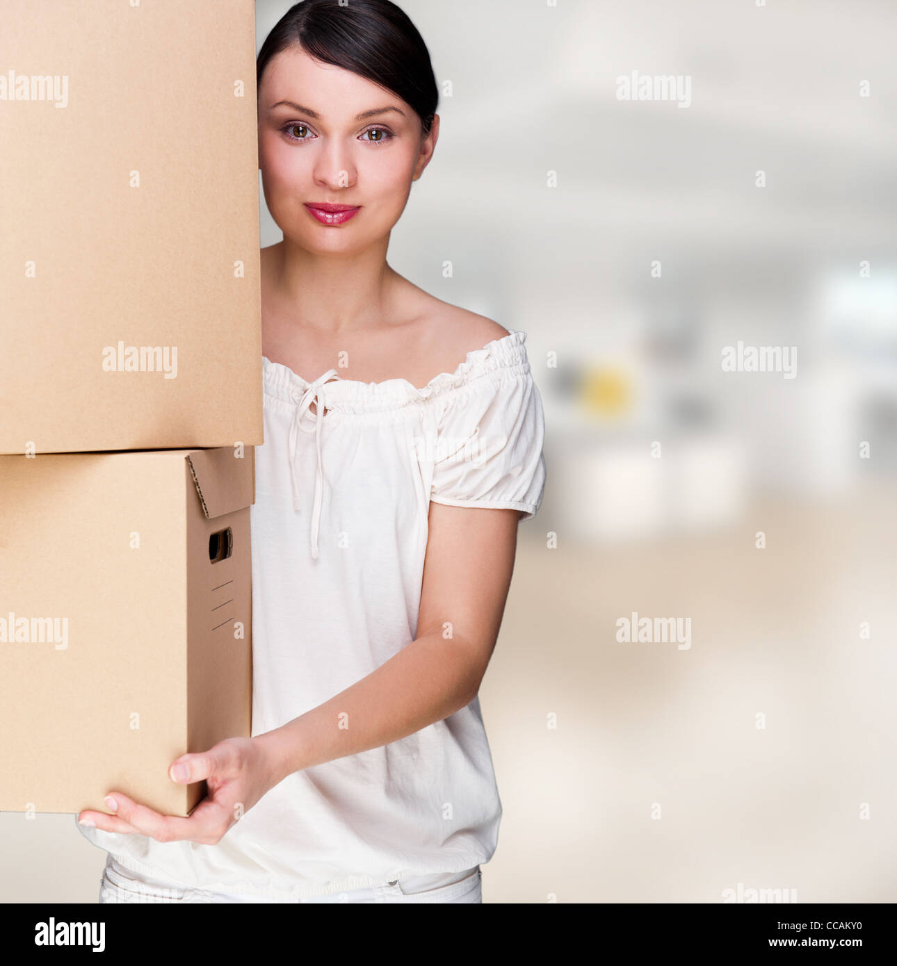 Attractive woman with box making a removal Stock Photo - Alamy