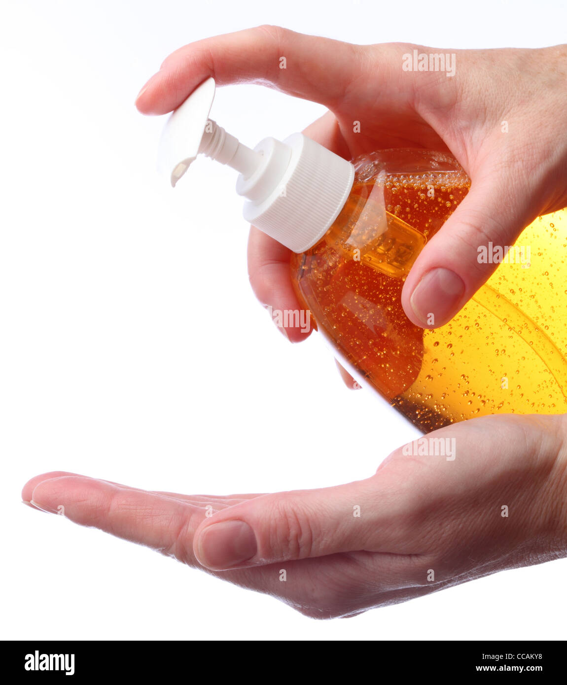Applying liquid soap. Two hands holding bottle with liquid soap ...