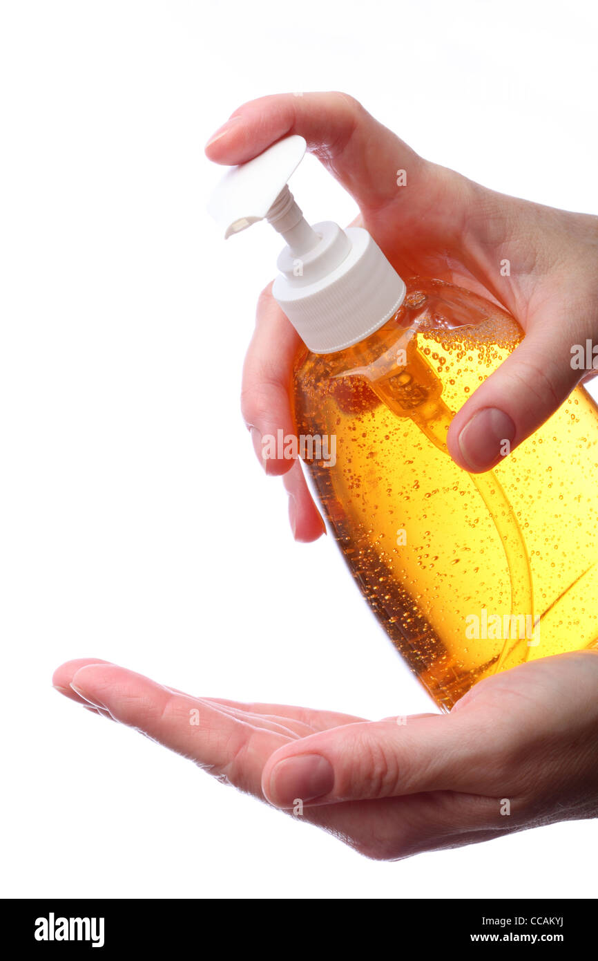 Applying liquid soap. Two hands holding bottle with liquid soap ...
