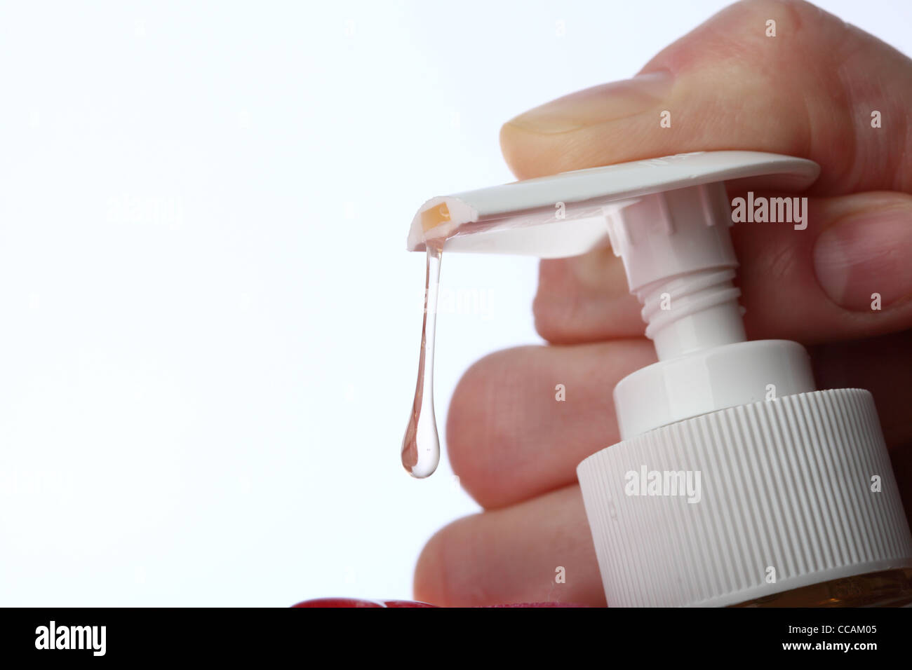 Applying liquid soap. Two hands holding bottle with liquid soap ...