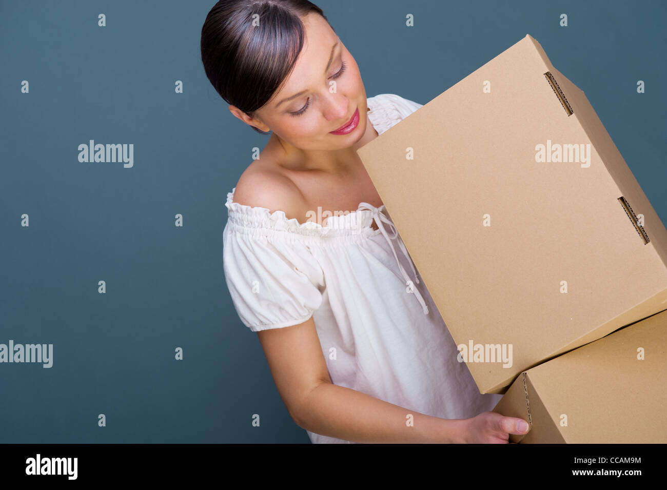 Closeup Portrait of a young woman with boxes Stock Photo - Alamy