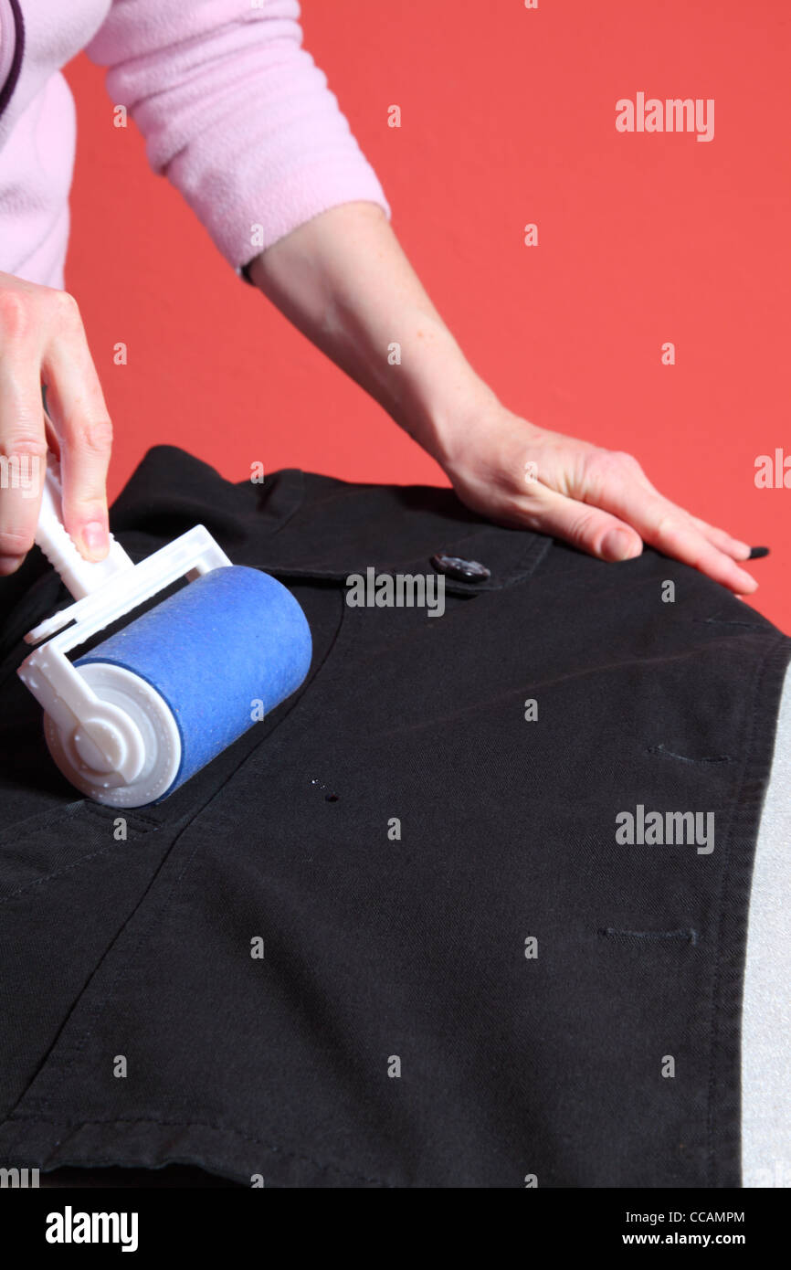Woman cleaning lint roller hi-res stock photography and images - Alamy