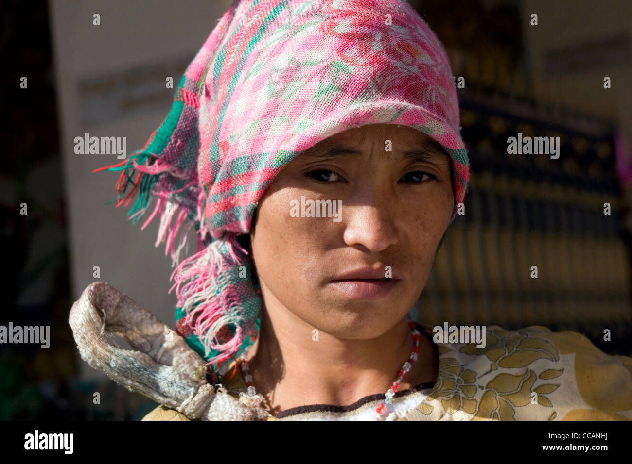 An ethnic hill tribe woman is wearing traditional clothing in Mae Sai ...