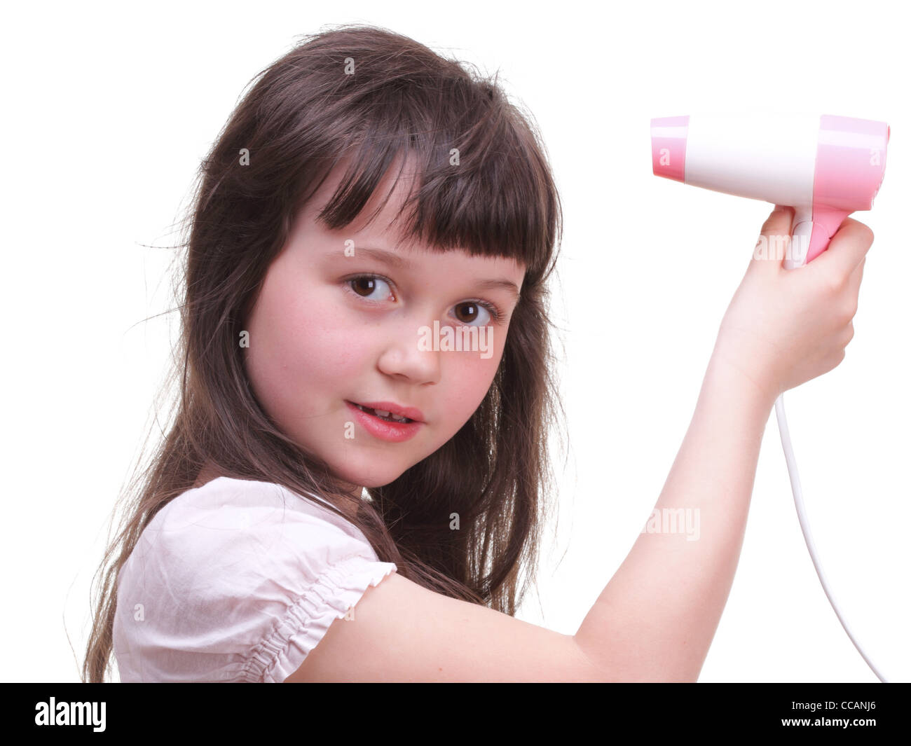 Pretty girl drying her hair hairdryer isolated on white Stock Photo - Alamy