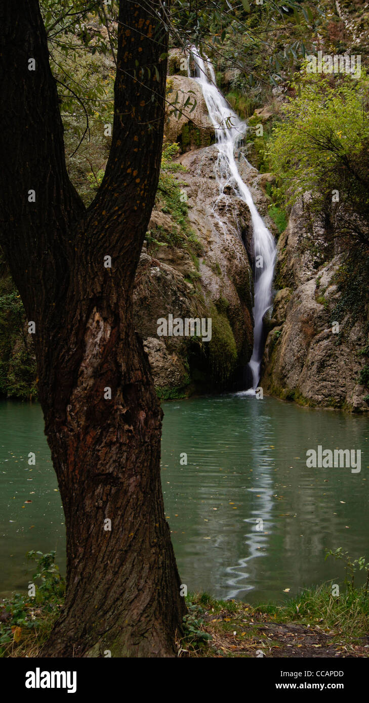 Elegant waterfall reflecting in a pond Stock Photo - Alamy
