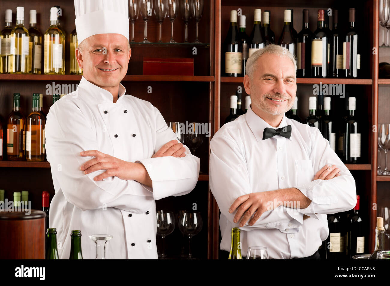 Chef cook and waiter smiling in restaurant wine bar Stock Photo - Alamy