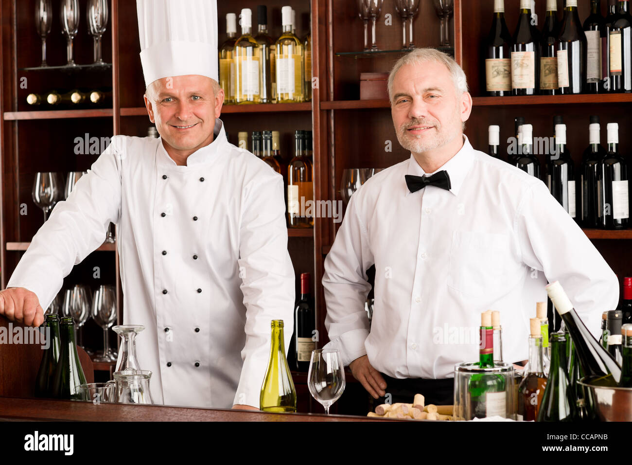 Chef cook and waiter smiling in restaurant wine bar Stock Photo - Alamy