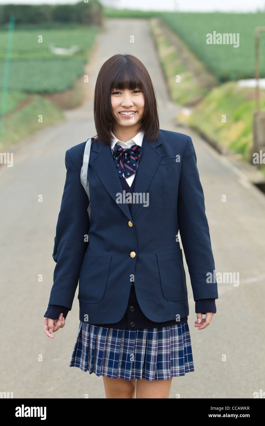 Female High School Student Standing on Rural Road Stock Photo - Alamy