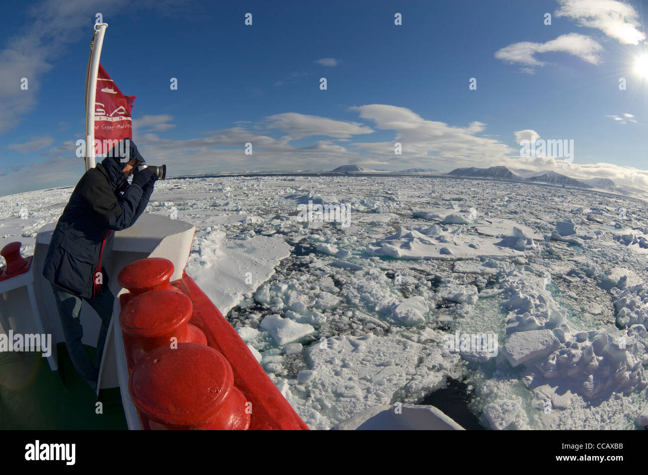 Tourist photographing floating drift ice formed into pack ice, from an ...