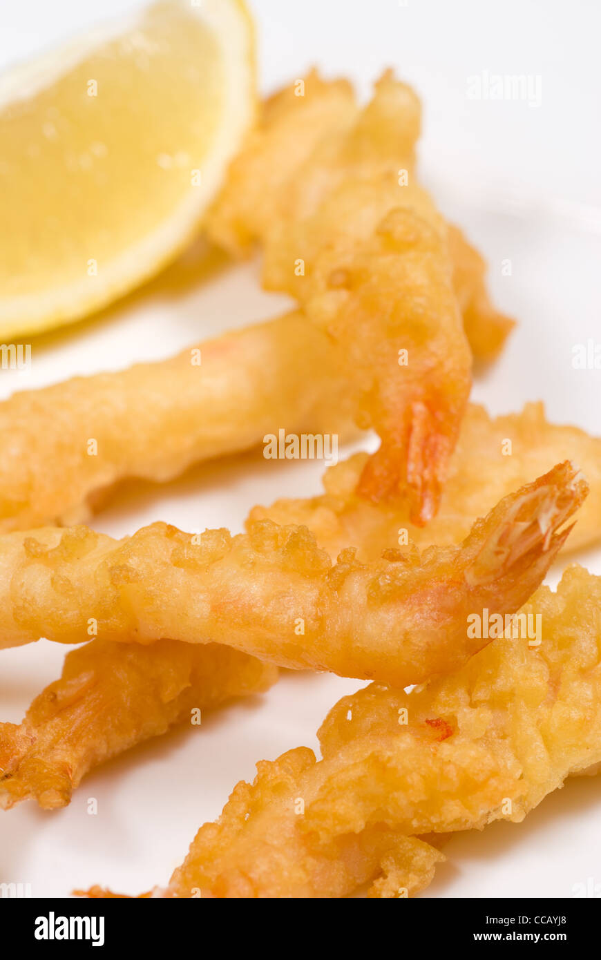 Tempura prawns served with a slice of lemon Stock Photo - Alamy