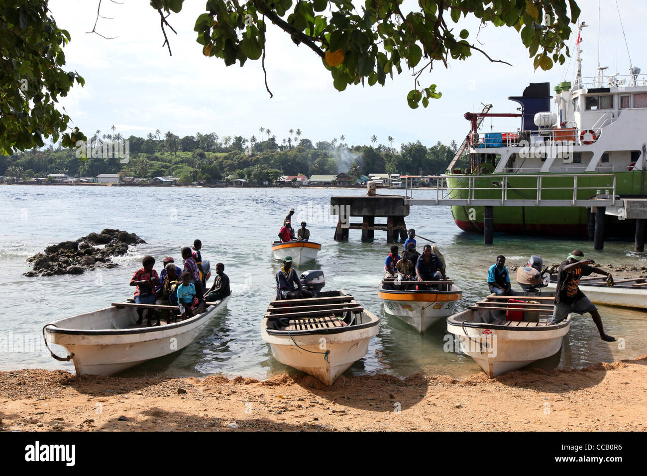 small boats ferries passengers between Buka Island (front) and ...