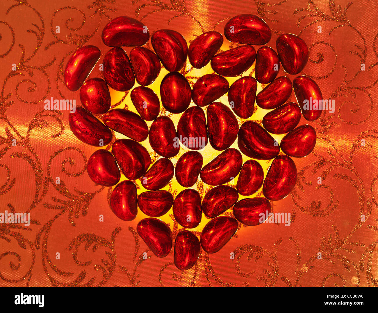 Hot red heart on red ornament Stock Photo - Alamy