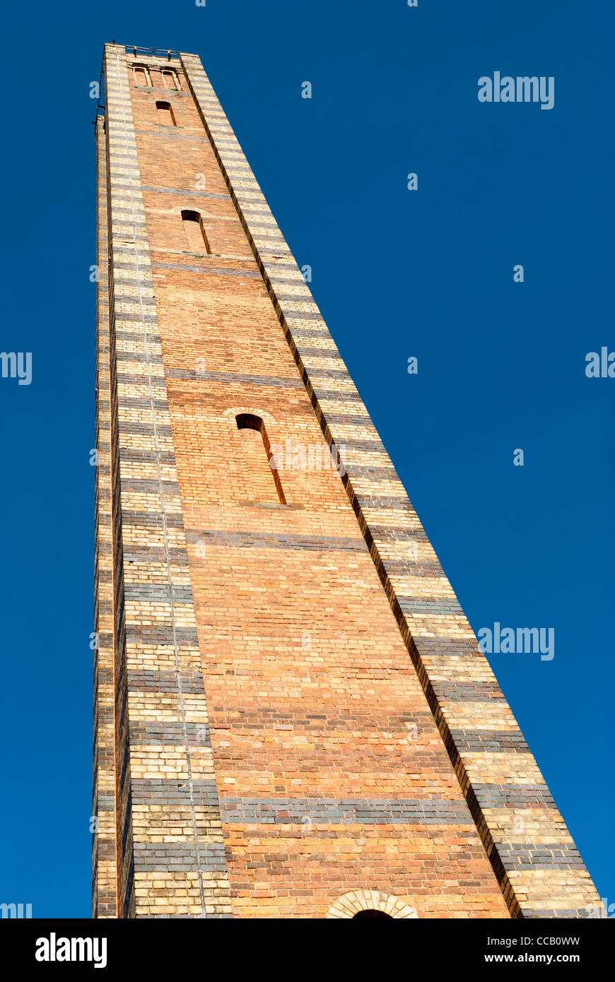 Decorative brick chimney against deep blue sky Stock Photo - Alamy