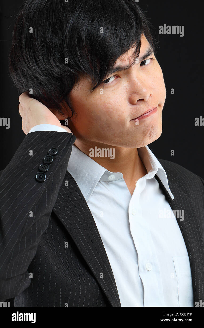 Executive standing with concerned look Stock Photo - Alamy