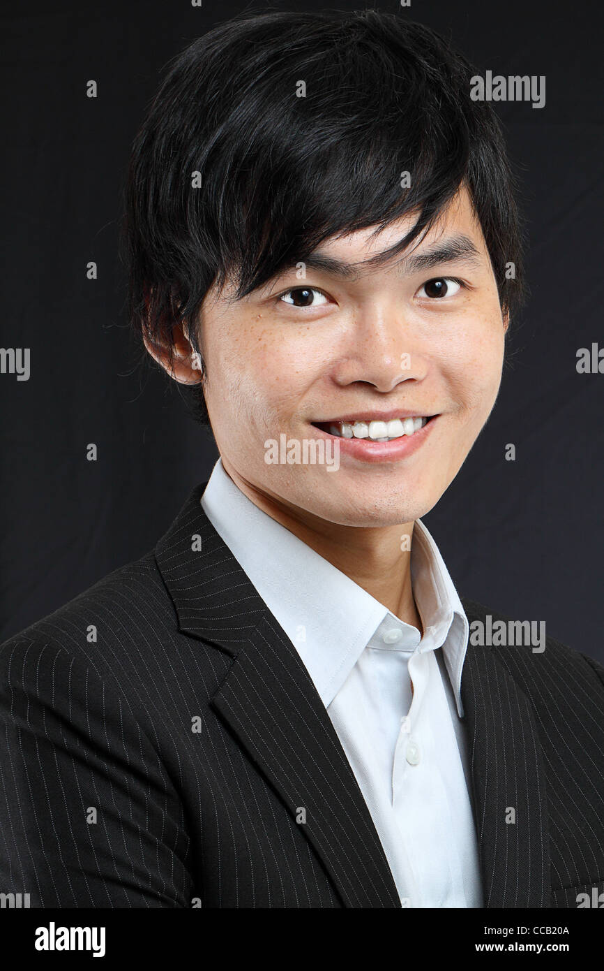 Young asian man in black suit Stock Photo - Alamy