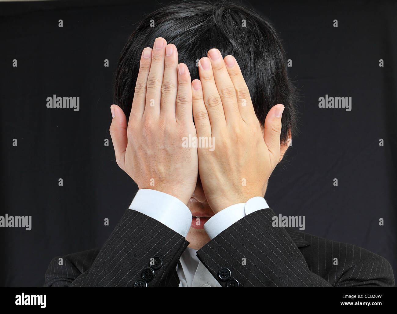 businessman covering his face by hands Stock Photo - Alamy