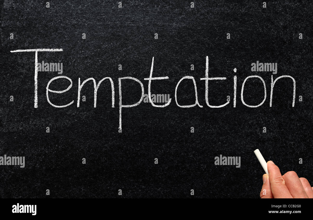 Writing temptation with white chalk on a blackboard Stock Photo - Alamy