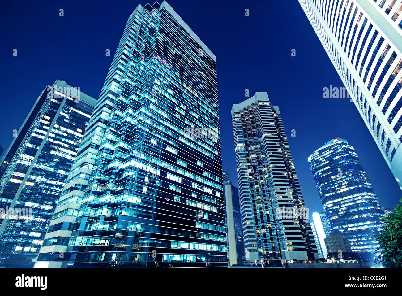 Tall office buildings by night Stock Photo - Alamy
