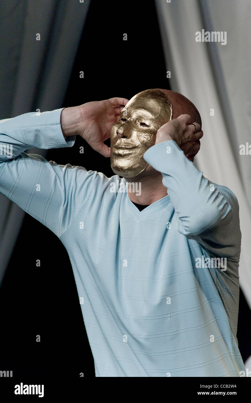 A Mime Artist on stage in a golden Mask Stock Photo - Alamy