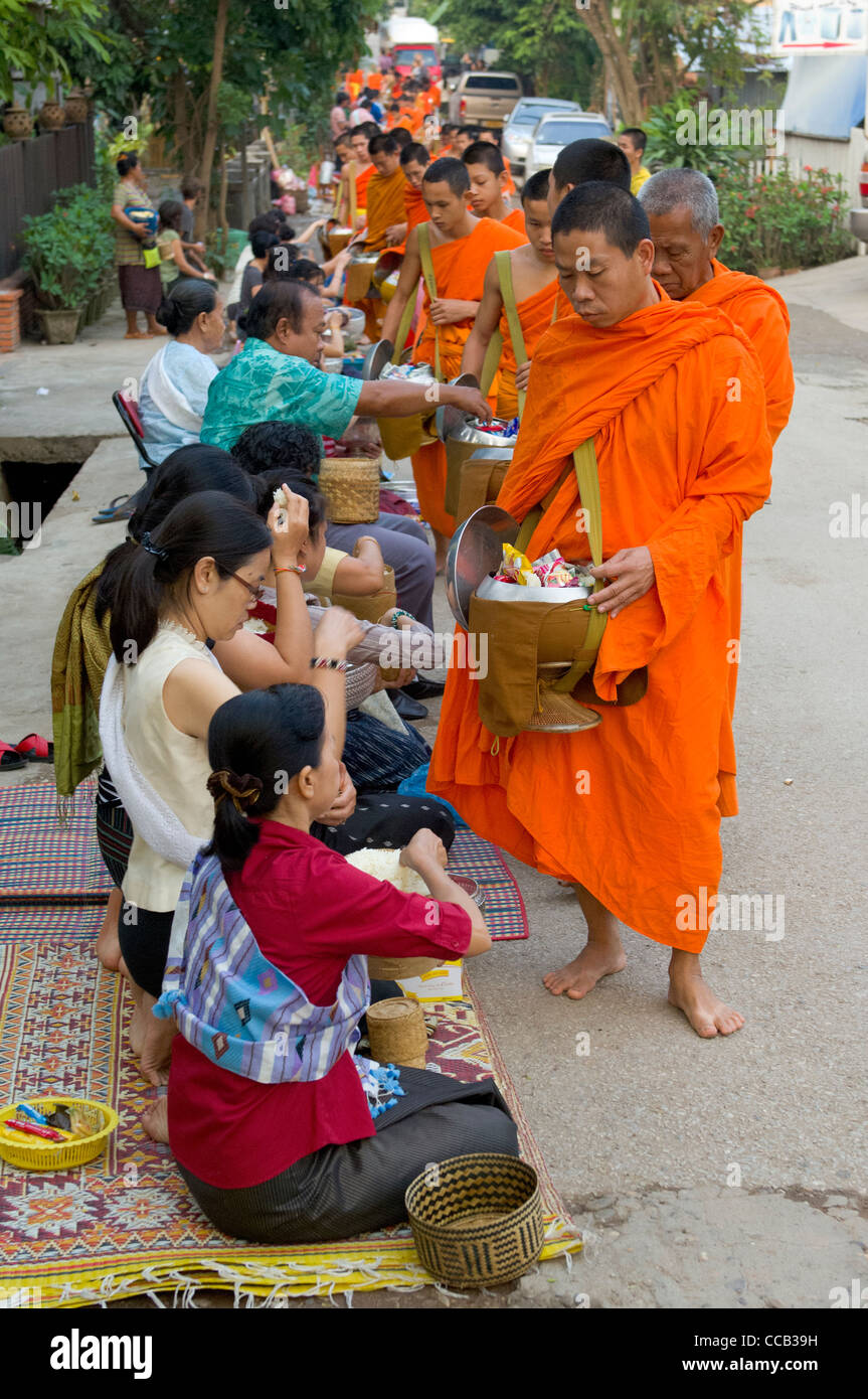 Buddhist monks on their morning alms round on the first day of the new ...
