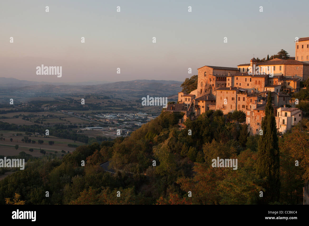 The setting sun illuminates the city of Todi. Umbria, Italy Stock Photo ...