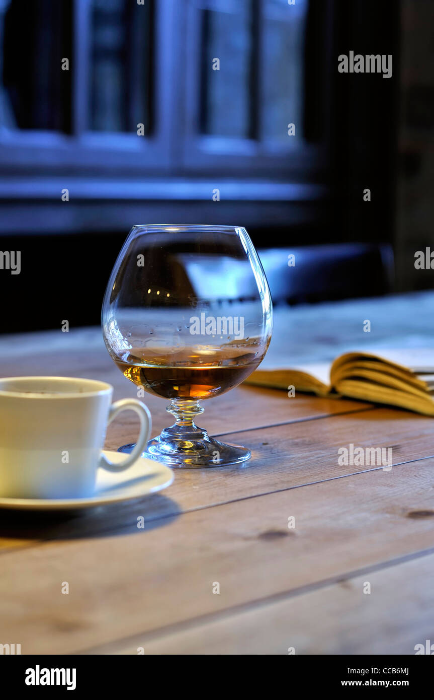cognac glass and coffee on the table at the French café Stock Photo - Alamy
