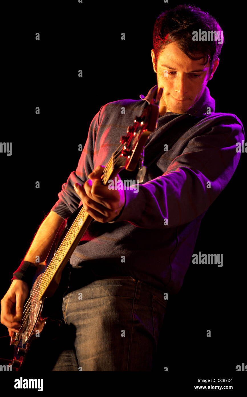 Man Playing Electric Bass on Black Background Stock Photo - Alamy