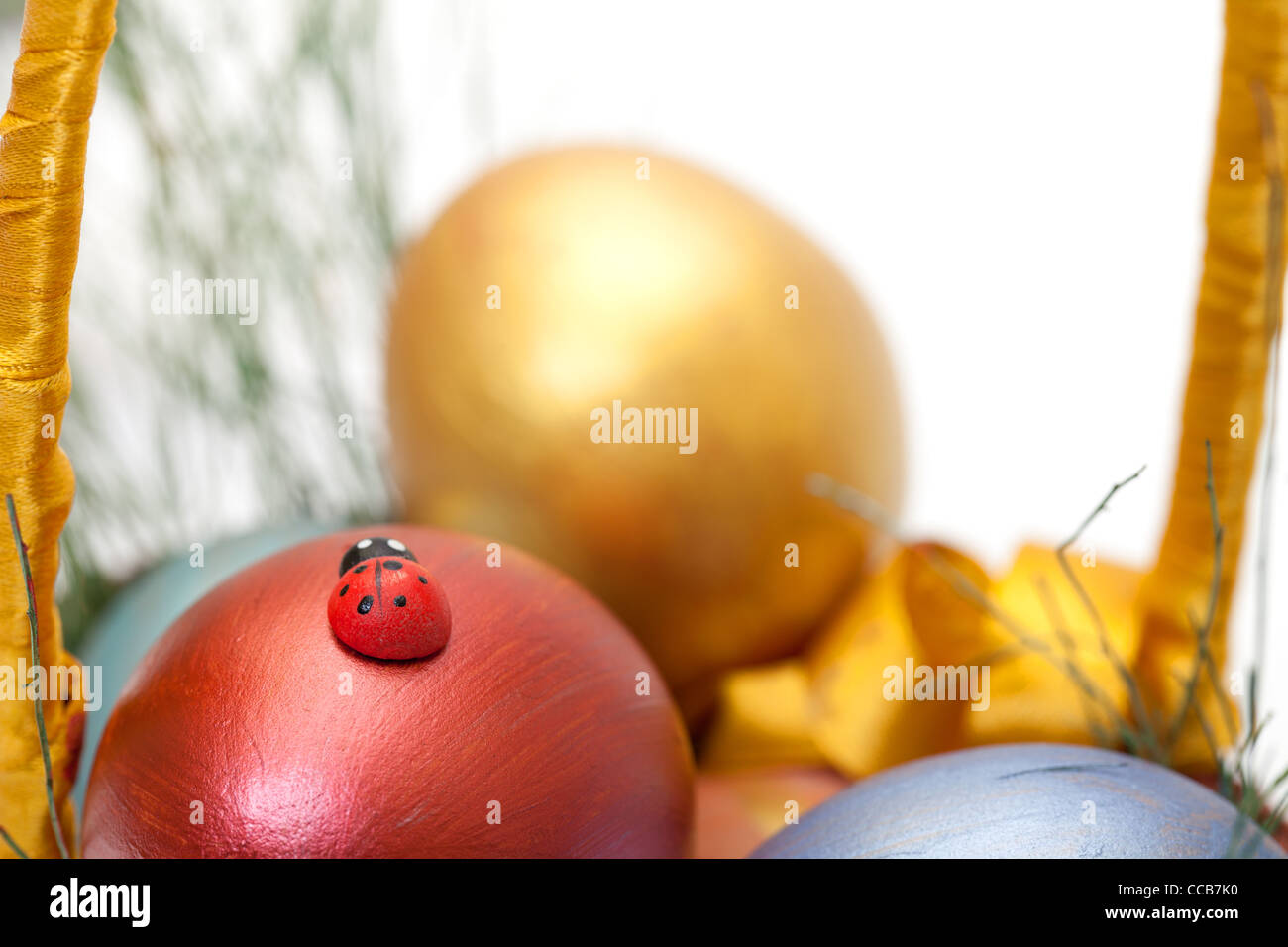 ladybug on painted easter eggs in basket, closeup Stock Photo - Alamy