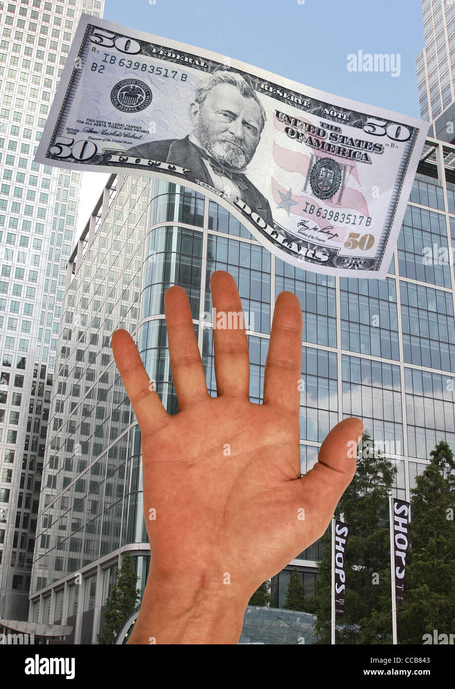 Hand reaching for a fifty dollar note with city background Stock Photo ...