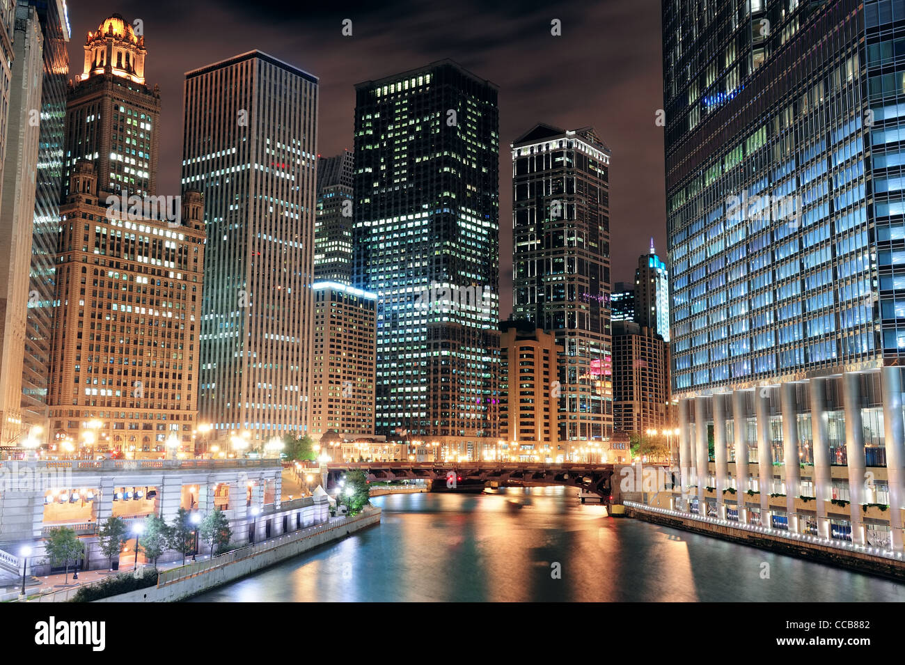 Chicago River Walk with urban skyscrapers illuminated with lights and ...