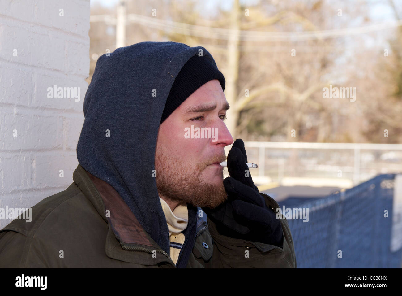 Homeless man smoking cigarette hi-res stock photography and images - Alamy