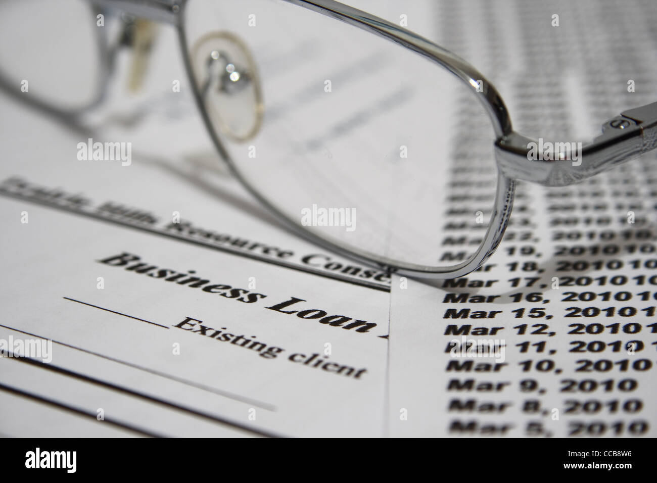 glasses on document Stock Photo - Alamy