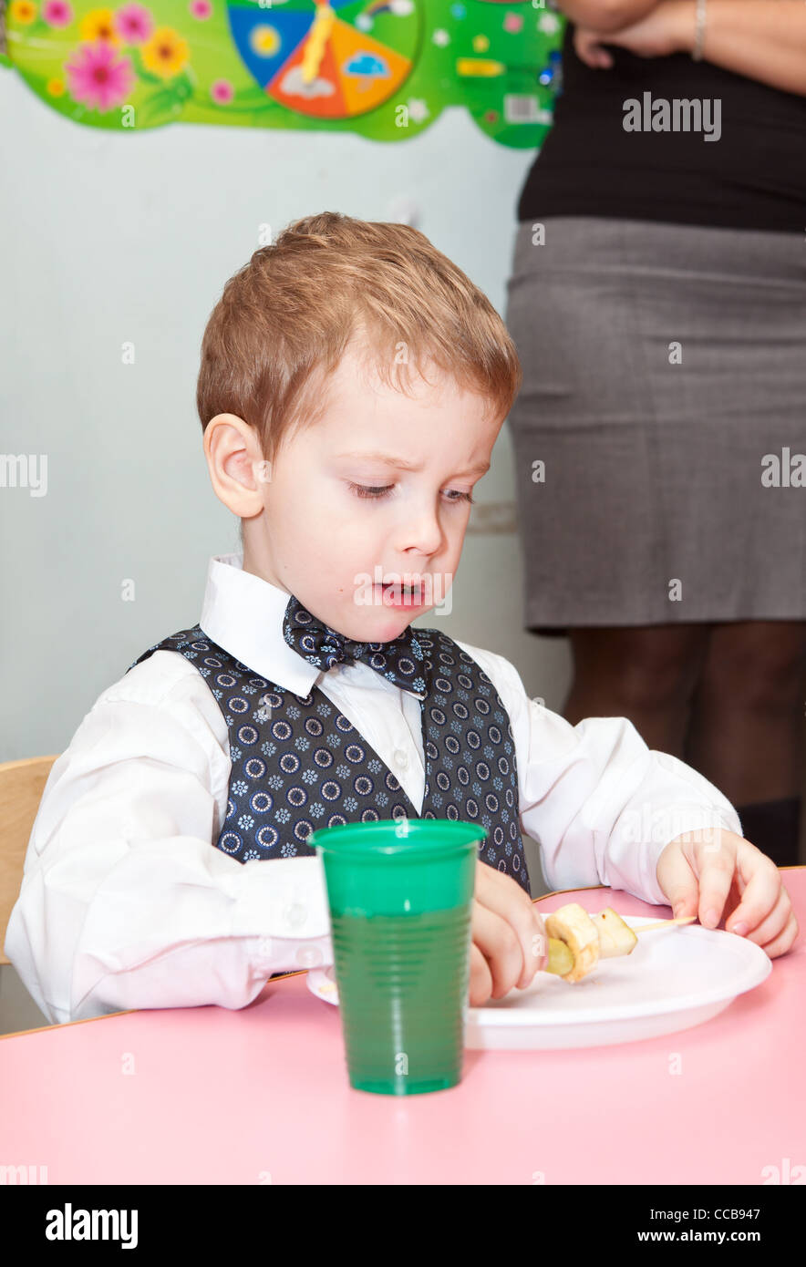 Children in Russian kindergarten sitting at the dinner table and eating ...