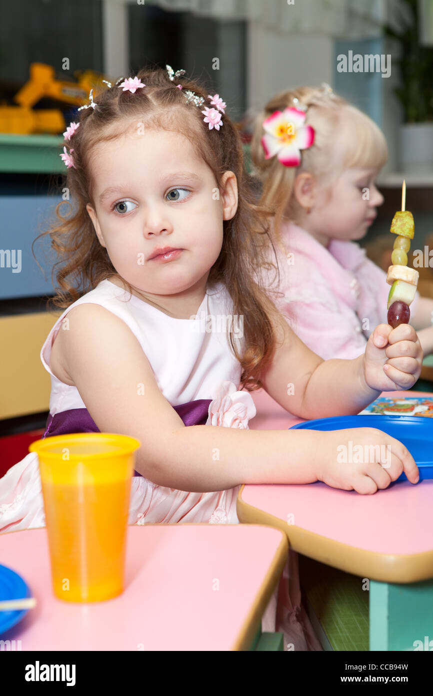 Children in Russian kindergarten sitting at the dinner table and eating ...