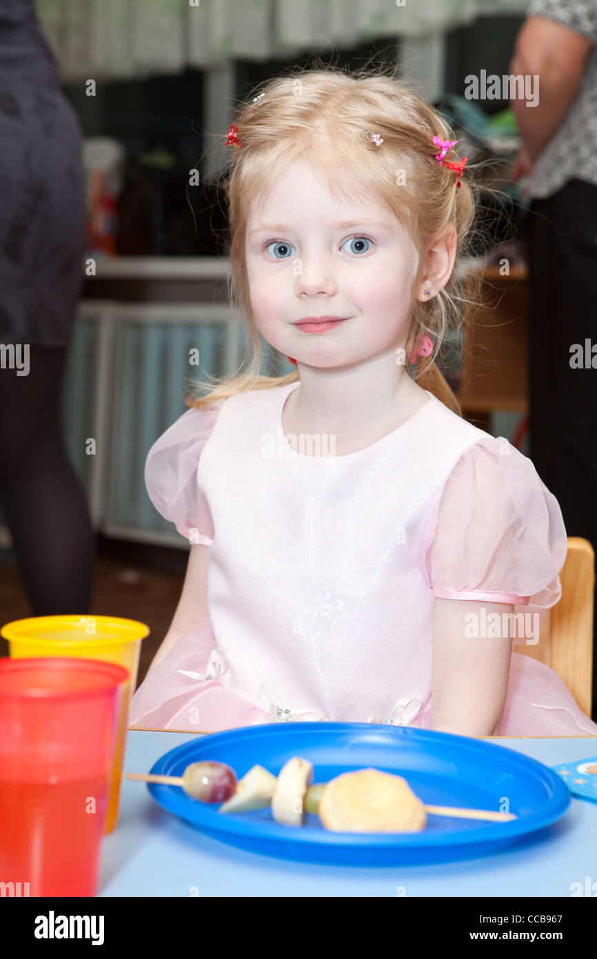 Children in Russian kindergarten sitting at the dinner table and eating ...