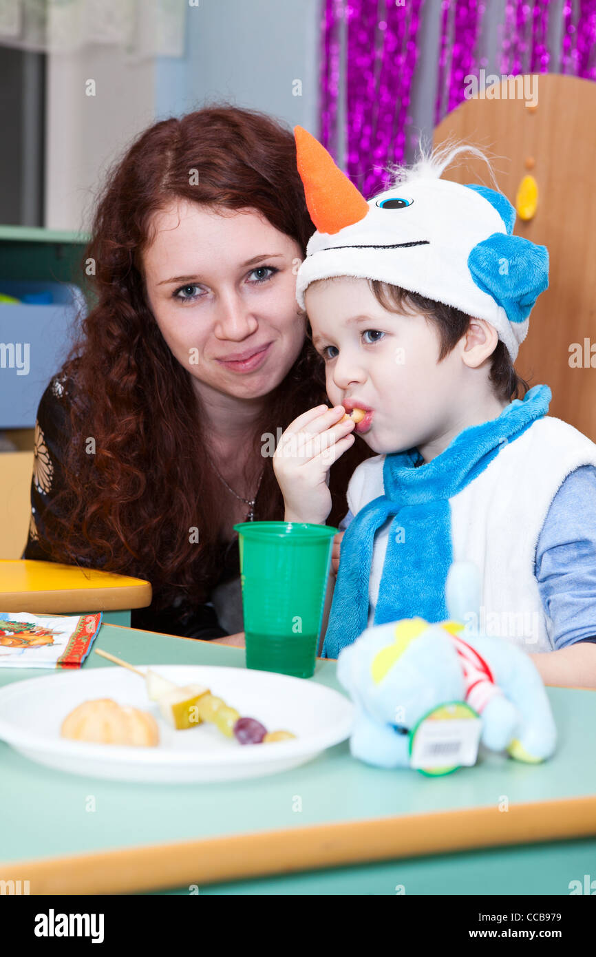 Children in Russian kindergarten sitting at the dinner table and eating ...