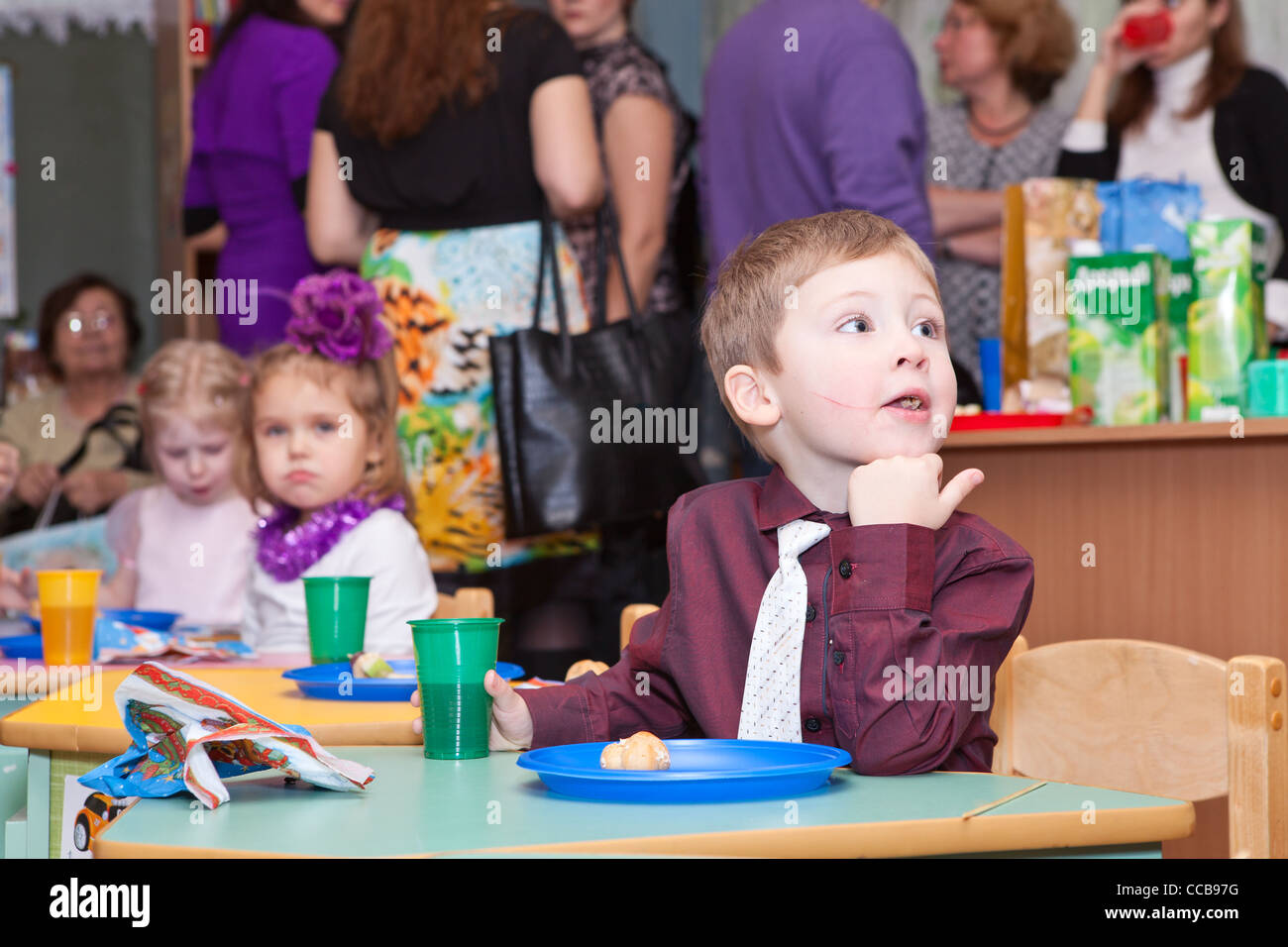 Children in Russian kindergarten sitting at the dinner table and eating ...