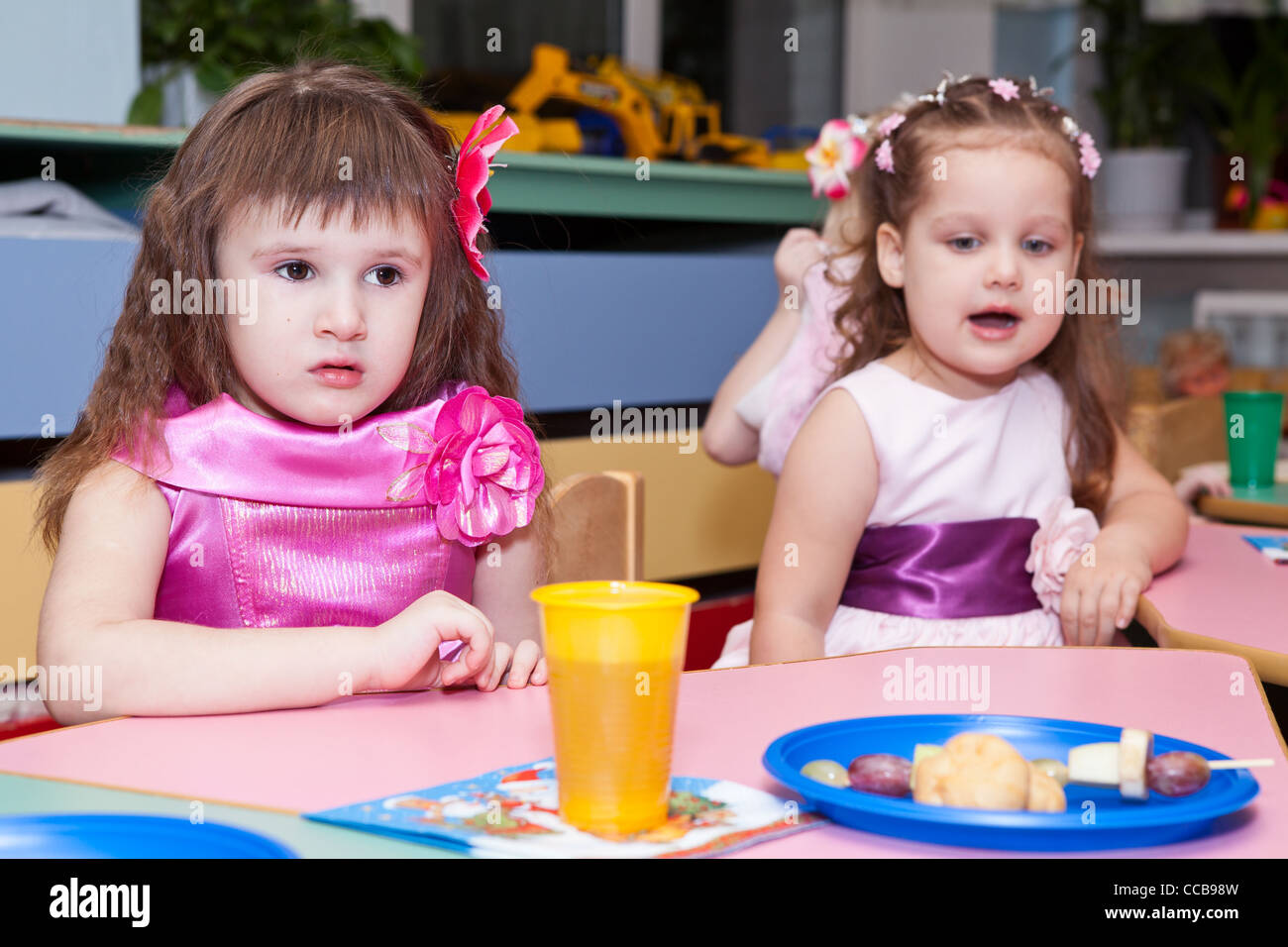 Children in Russian kindergarten sitting at the dinner table and eating ...