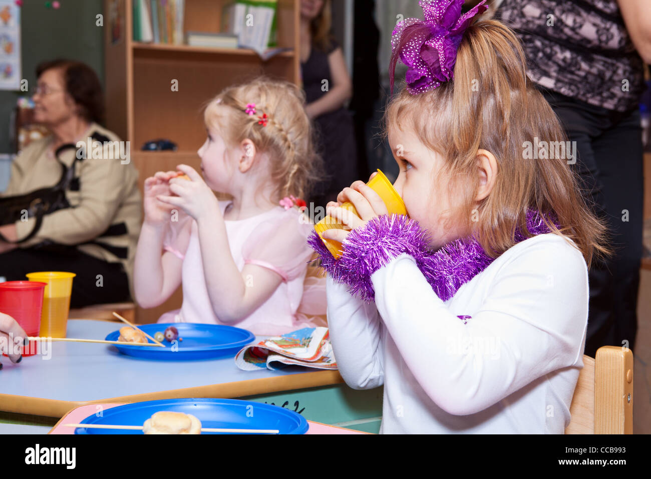 Children in Russian kindergarten sitting at the dinner table and eating ...