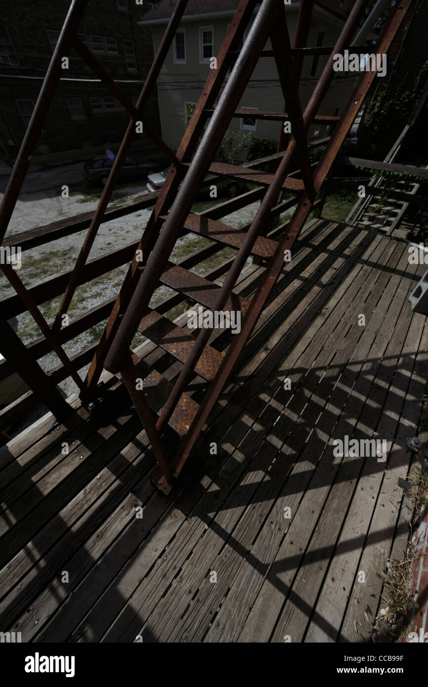 Steel fire-escape staircase on wood deck Stock Photo - Alamy