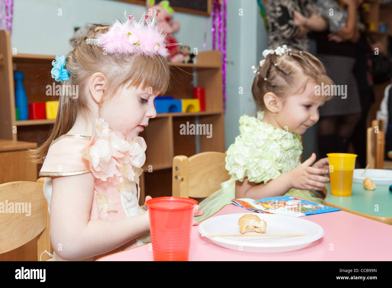 Children in Russian kindergarten sitting at the dinner table and eating ...