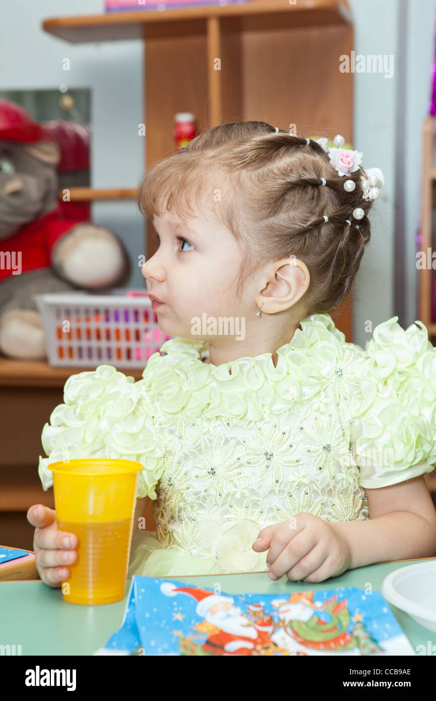 Children in Russian kindergarten sitting at the dinner table and eating ...
