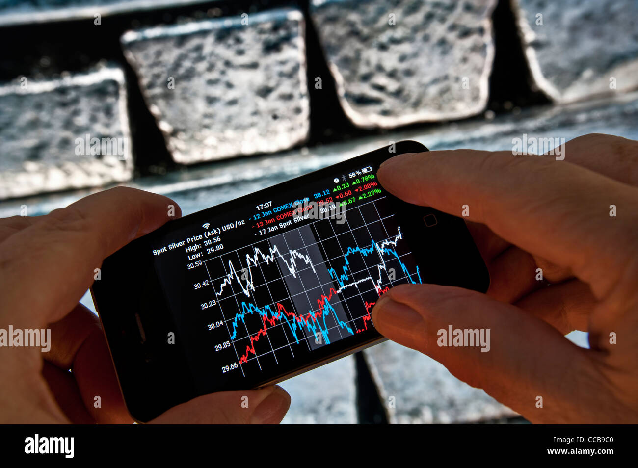 SILVER PRICE TRADING BUYING Hands holding Apple iPhone smartphone ...