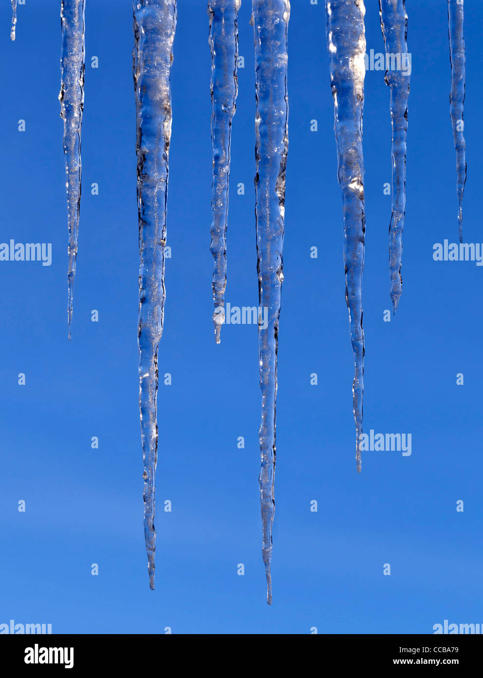 Large icicles against blue sky Stock Photo - Alamy