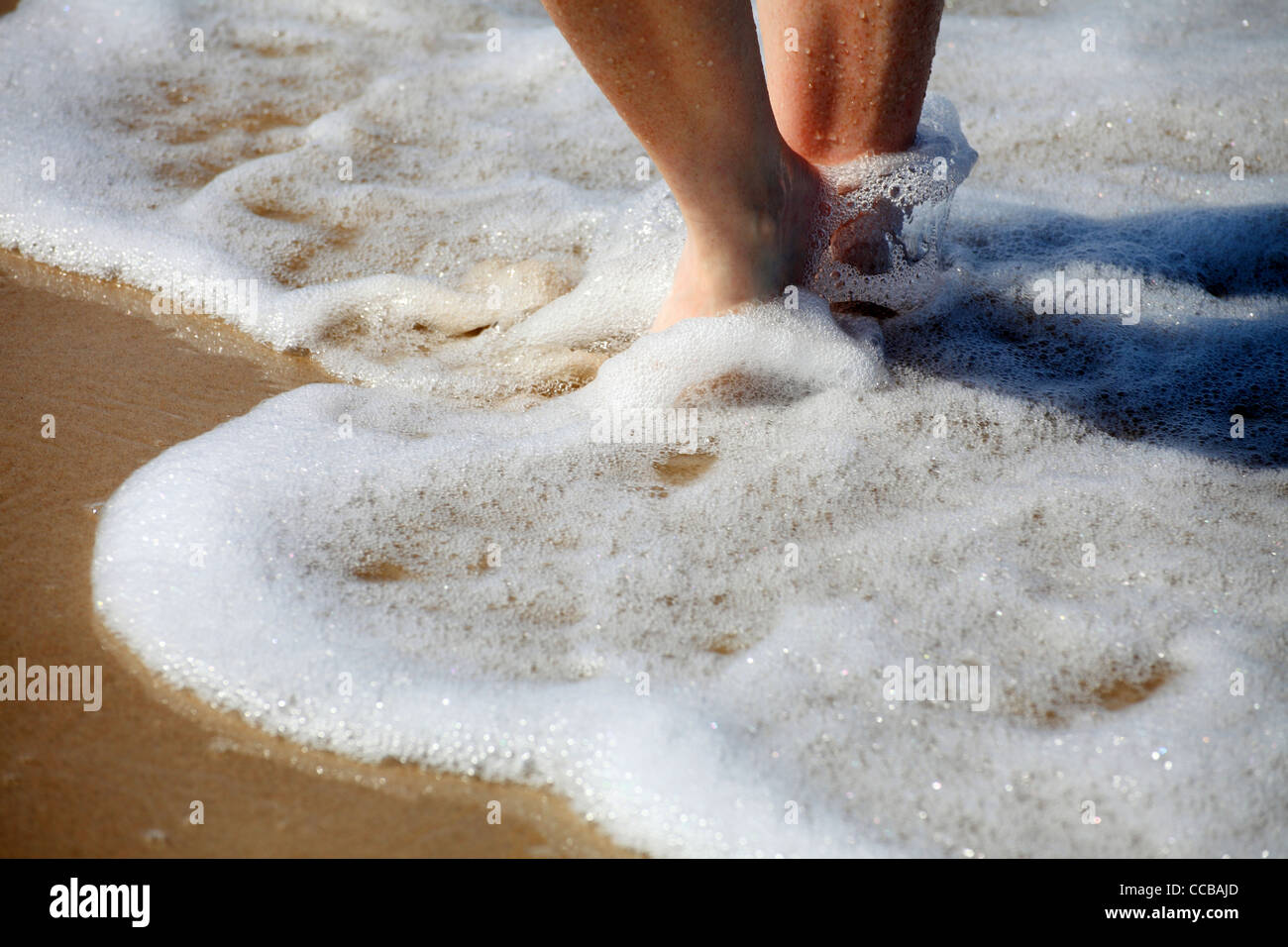 nice legs in water, nice pedicure red nail sand beach Stock Photo - Alamy