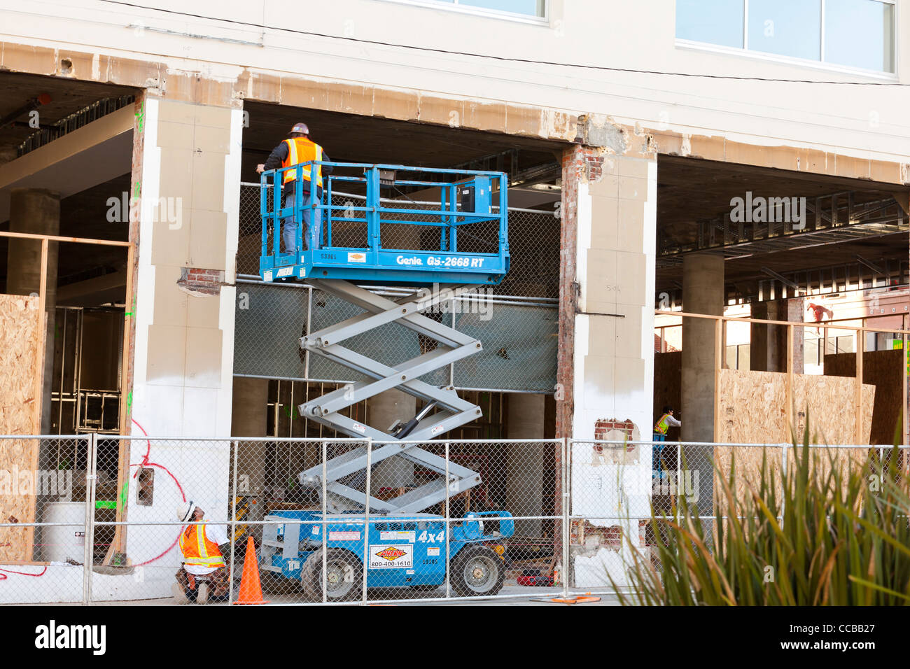 Man working on top of scissor lift work platform - USA Stock Photo - Alamy