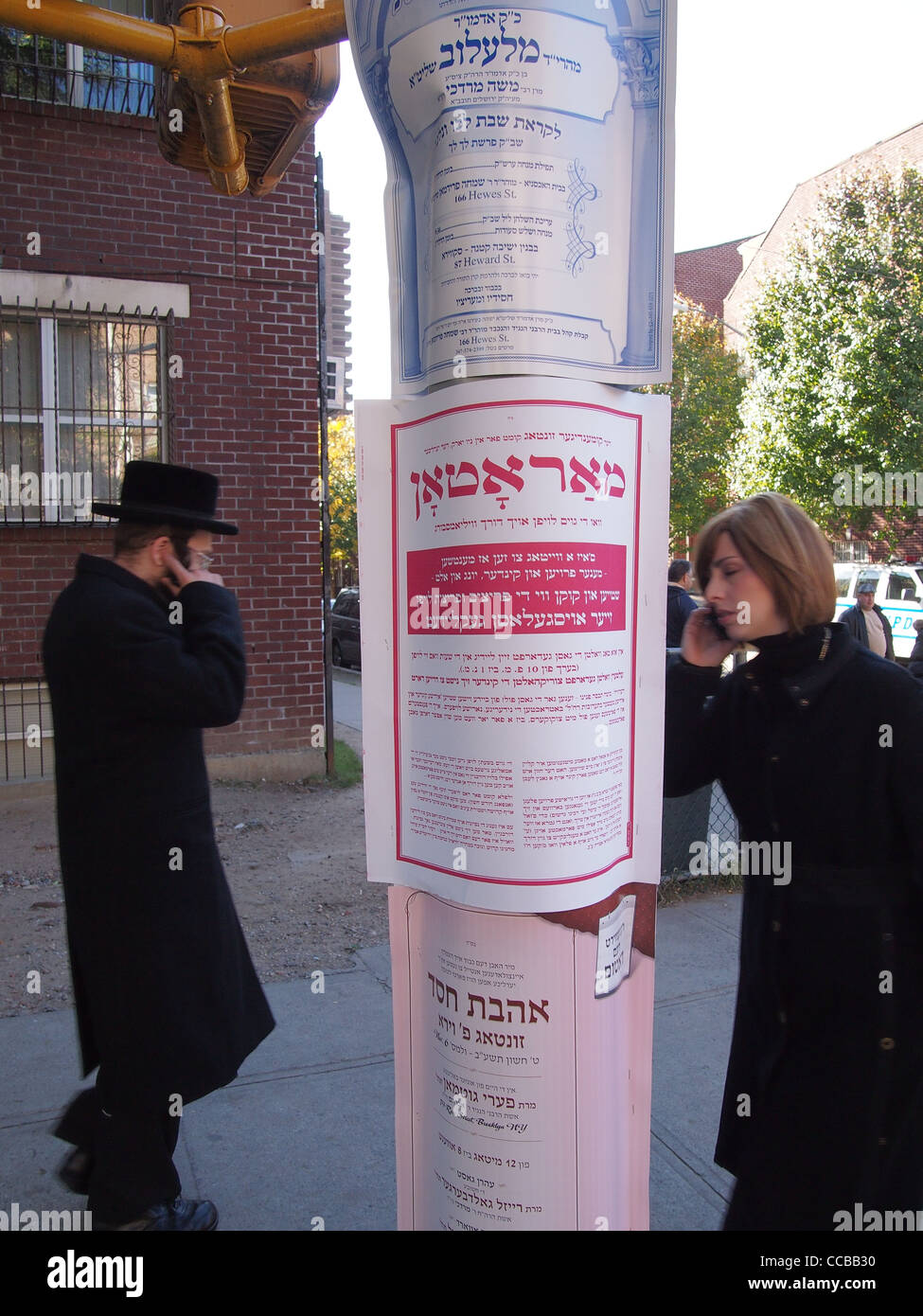 Hassidic Jewish man and woman using cell phones, Bedford Avenue ...