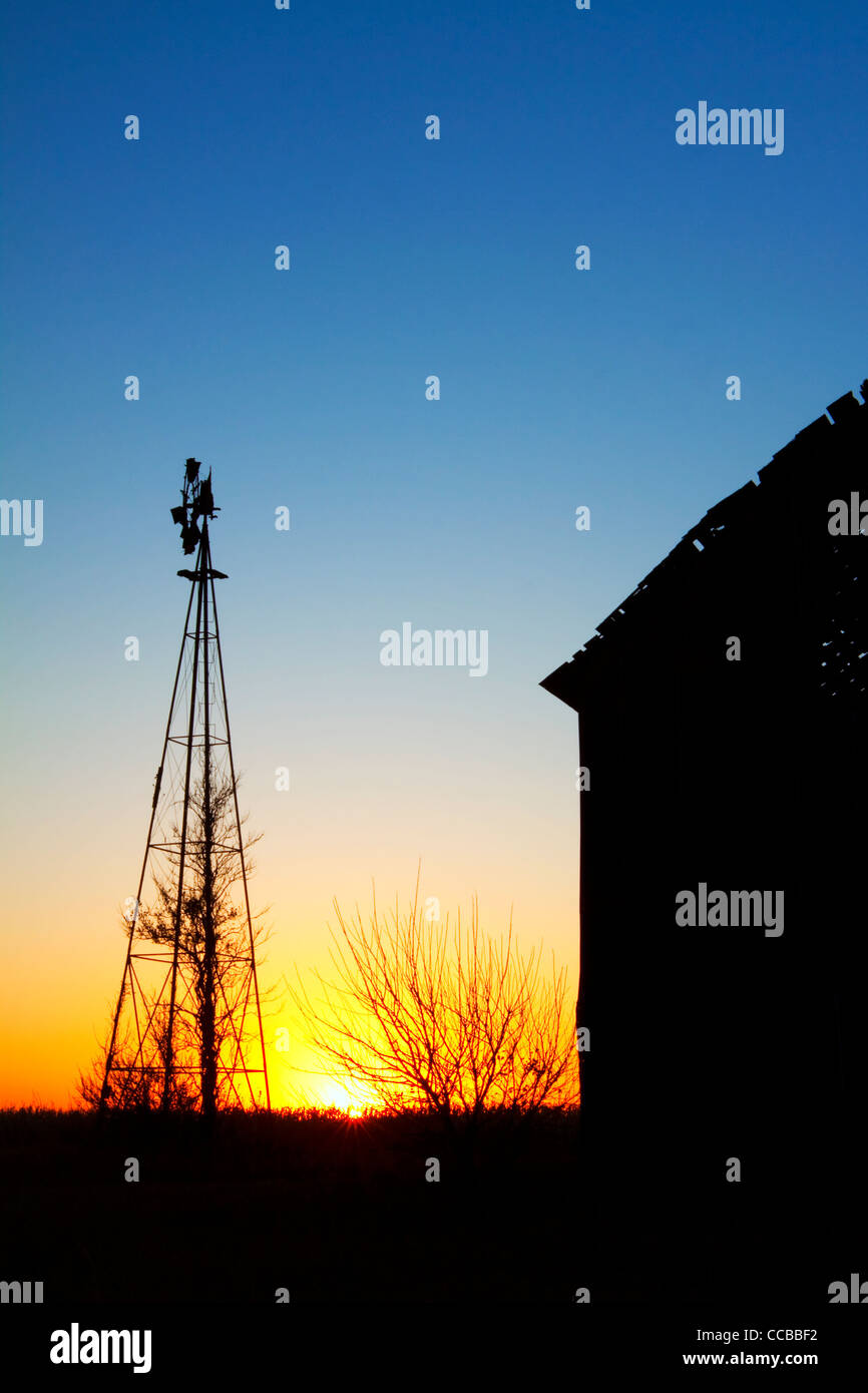 Silhouette of a barn and windmill at sunset Stock Photo - Alamy