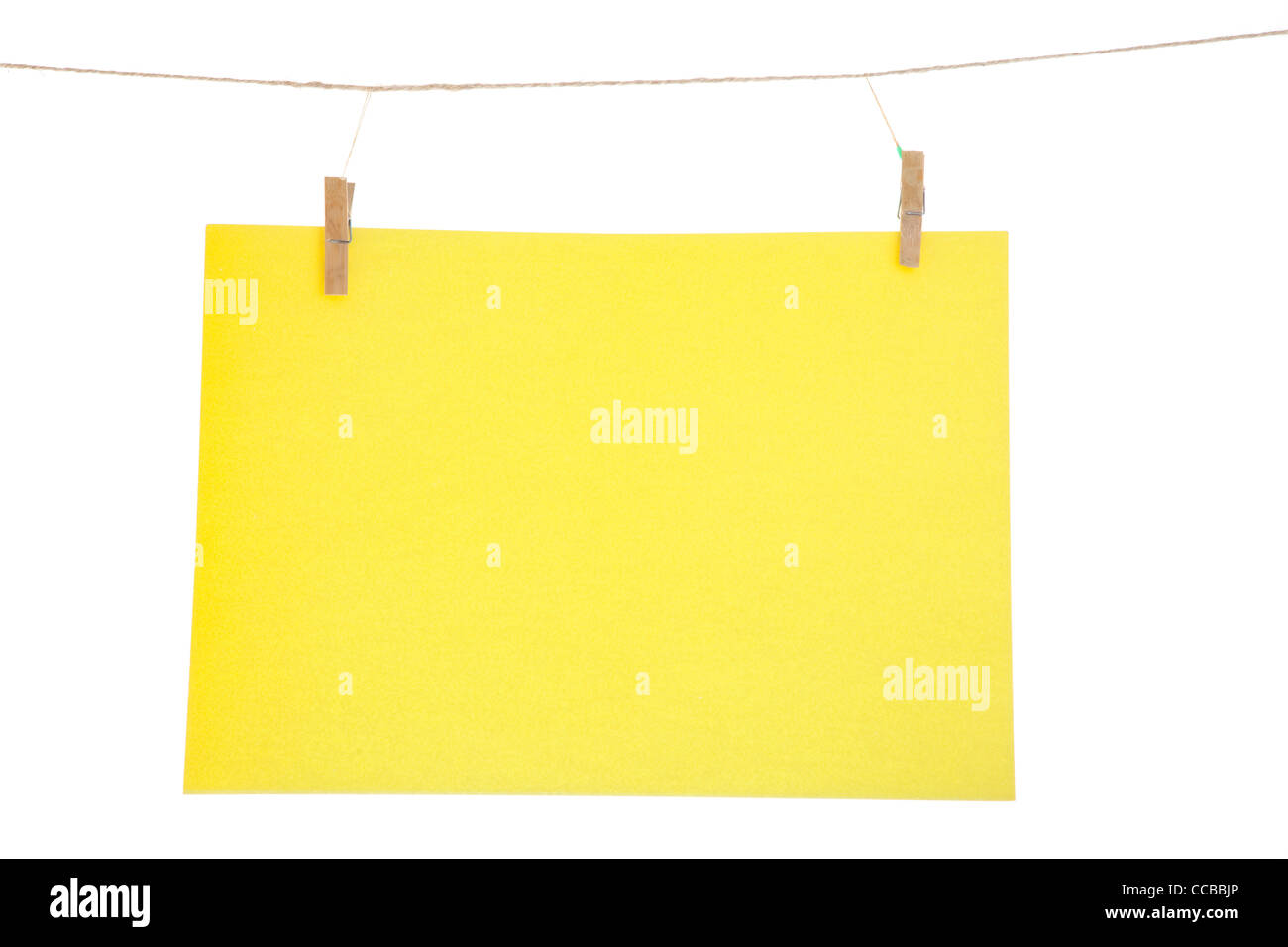 Orange blank paper sheet on a clothes line. Isolated on white ...